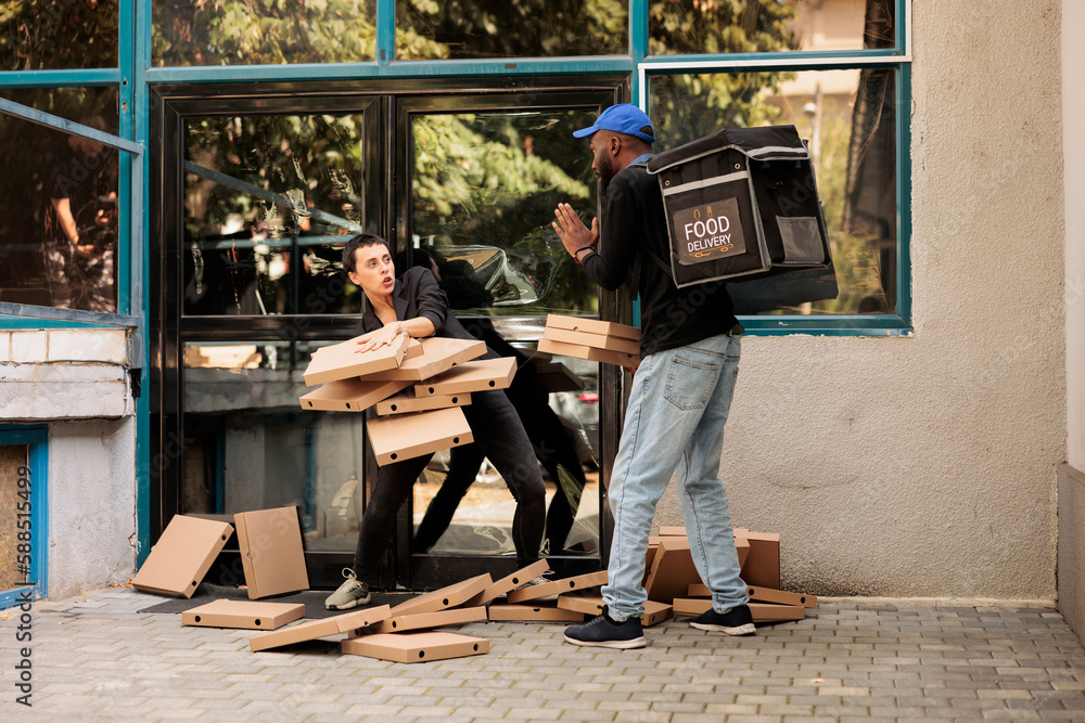 Foto de Confused woman catching falling pizza boxes stack, scared ...