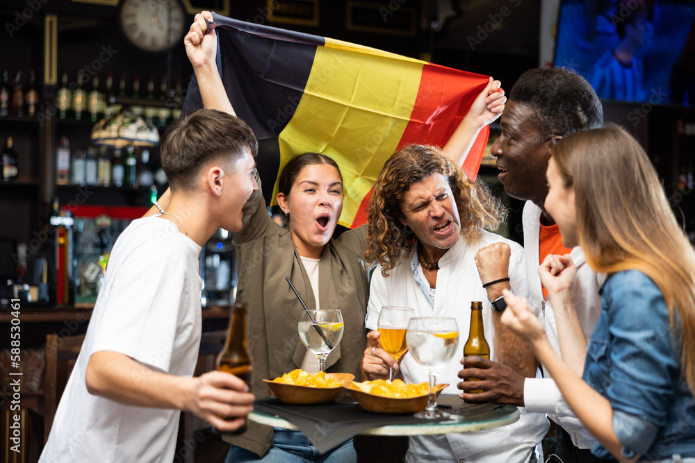 Excited young adults of different nationalities, sports fans ...