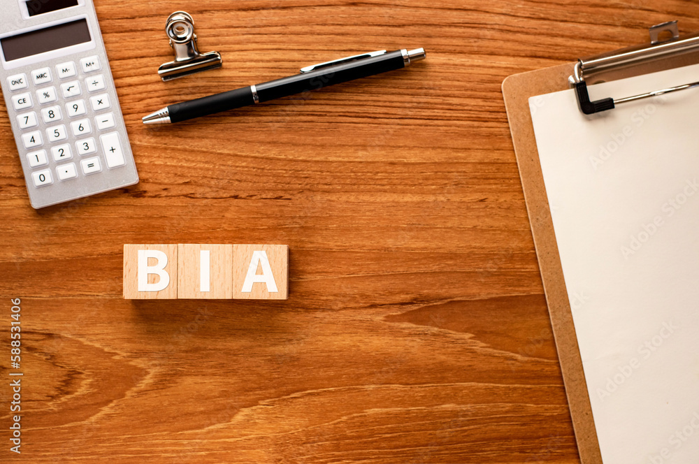 There is wood cube with the word BIA.It is an abbreviation for Business ...