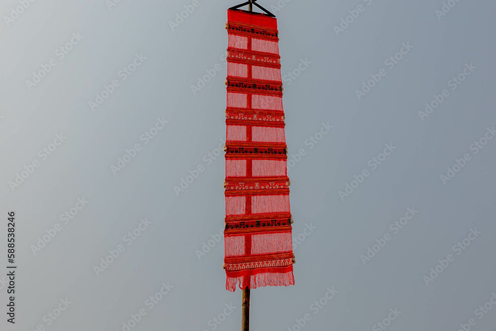 Handmade traditional red pink Lanna Tung hanging on the bamboo pole in ...