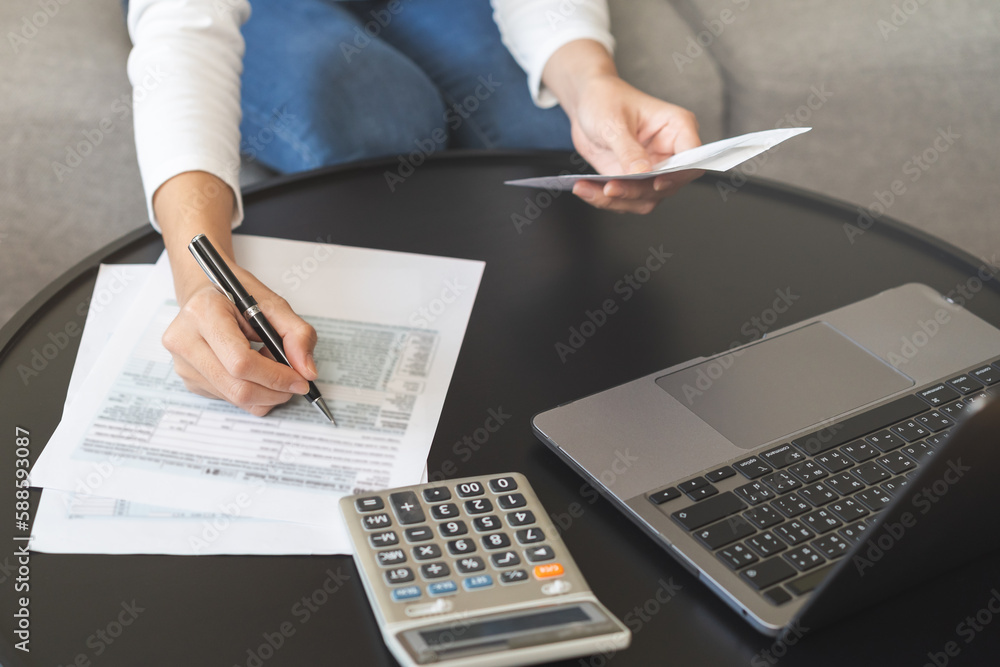 Deduction planning concept. Asian young woman hand using calculator to ...