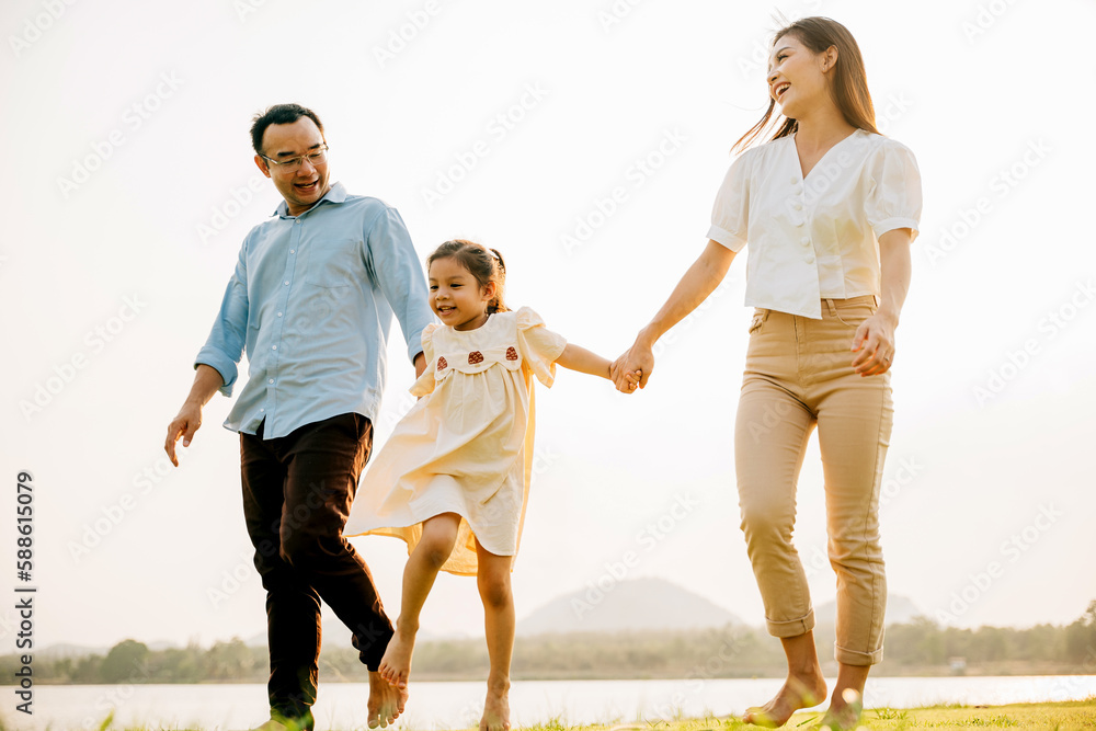 A happy family walking and playing together in a beautiful nature ...