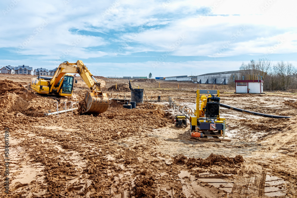Excavator dig the trenches at a construction site. Trench for laying ...