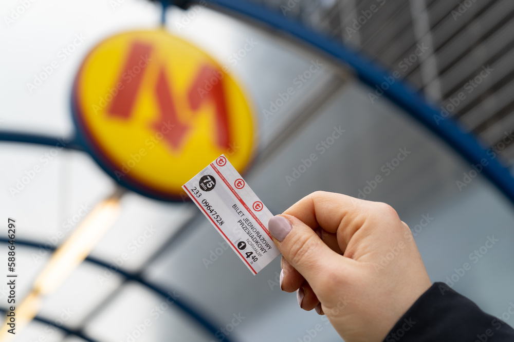 Hand holding single fare 75 minute transfer ticket, near entrance to ...