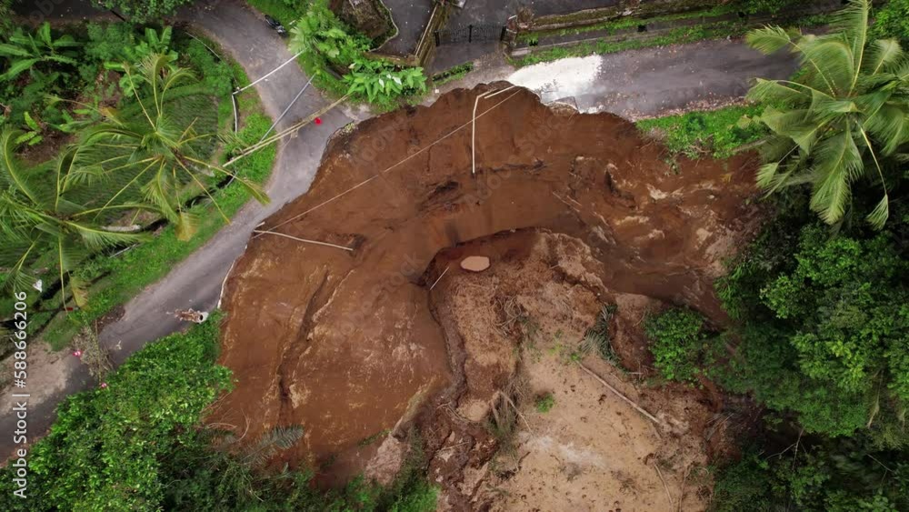 Destruction of road caused by dangerous landslide, top-down aerial shot ...
