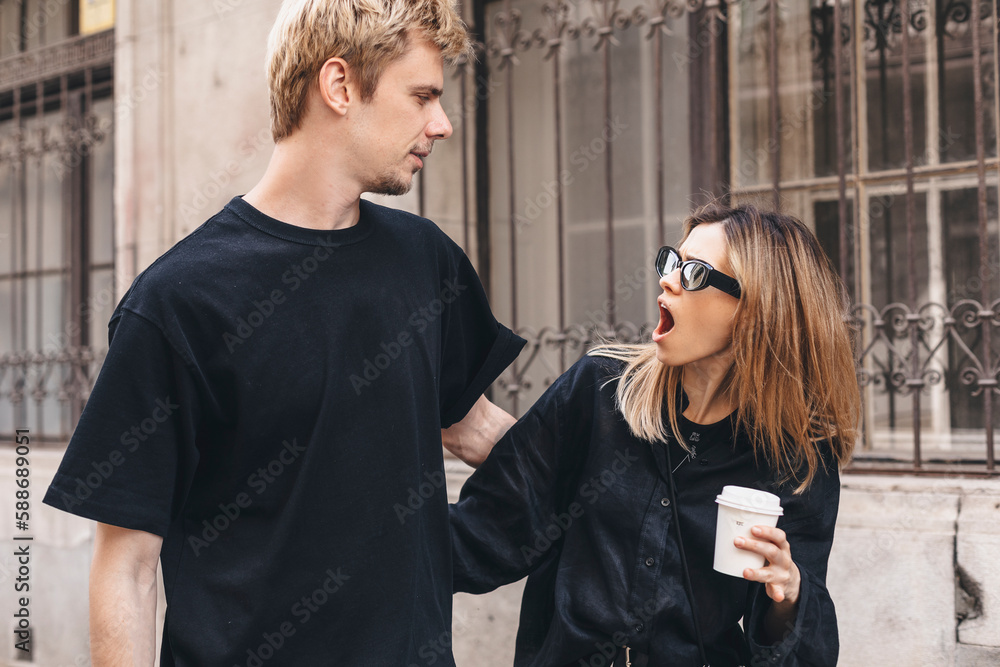 Couple walking outdoor, they hug. Woman look shocked with open mouth on ...