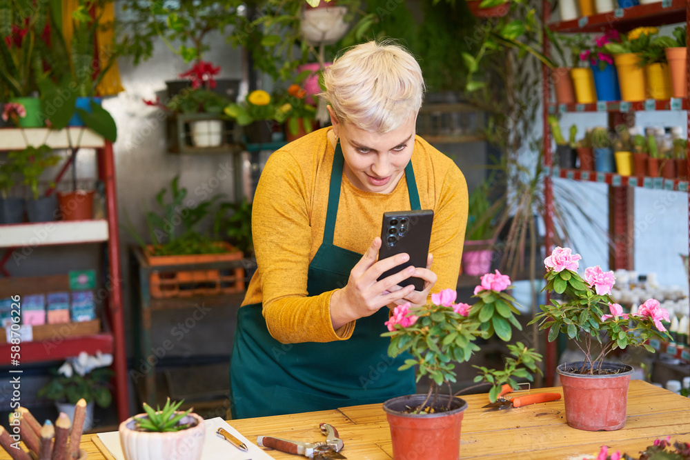 Floristin im Blumengeschäft macht Foto von Blume Stock Photo | Adobe Stock