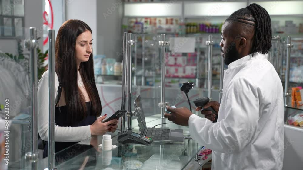 Witness the checkout process at the counter of a modern drugstore as ...