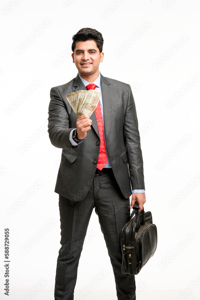 Young indian man in suit and showing indian rupees on white background ...