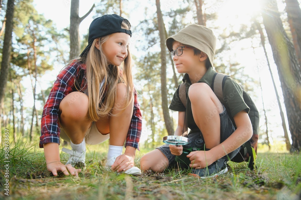 Kids exploring nature with magnifying glass. Summer activity for ...