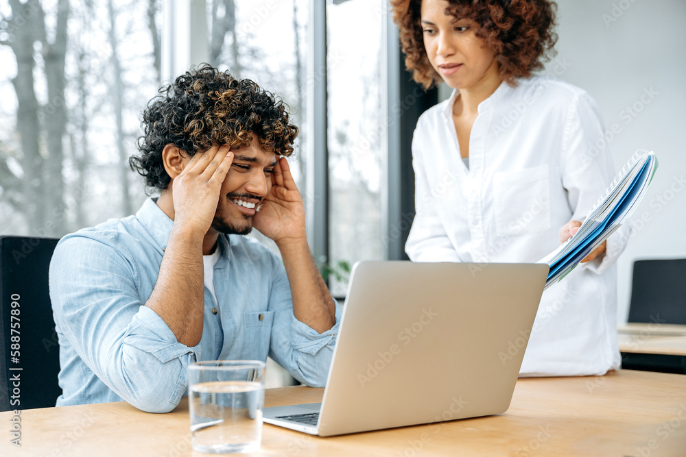 Multiracial man and woman, company colleagues, work together in the ...