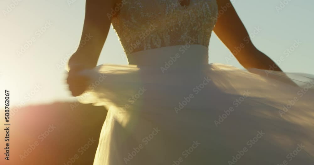 the torso of the bride's dress in the backlight. the bride twirls in ...