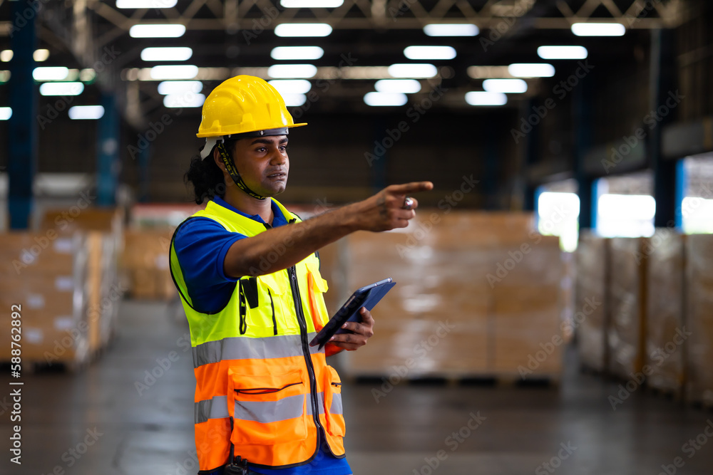 Portrait warehouse indian worker wearing safety hardhats helmet walking ...