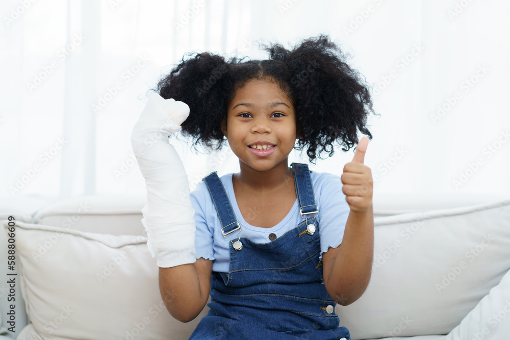 African - American black little girl have an accident at her right arm ...
