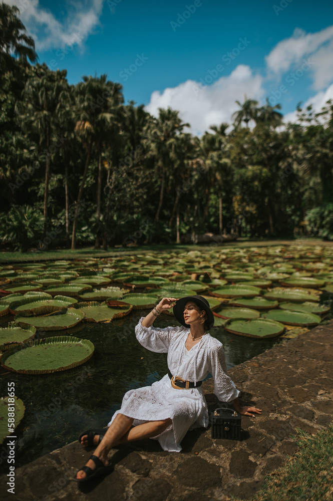 Young lady sitting in Sir Seewoosagur Ramgoolam botanical garden in ...
