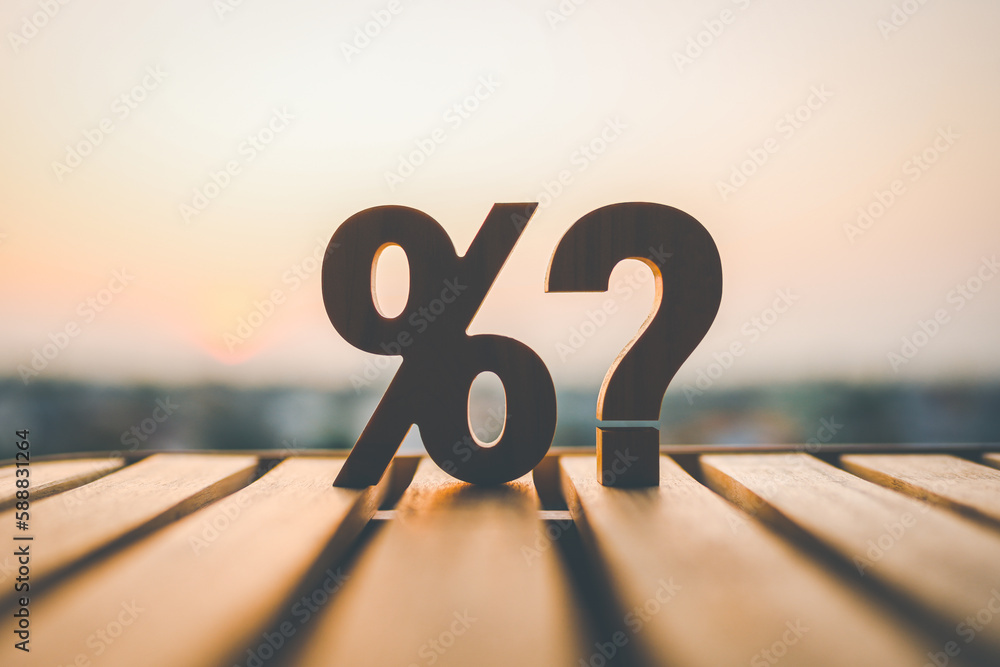 Percentage and question mark on wood table in blur urban background ...