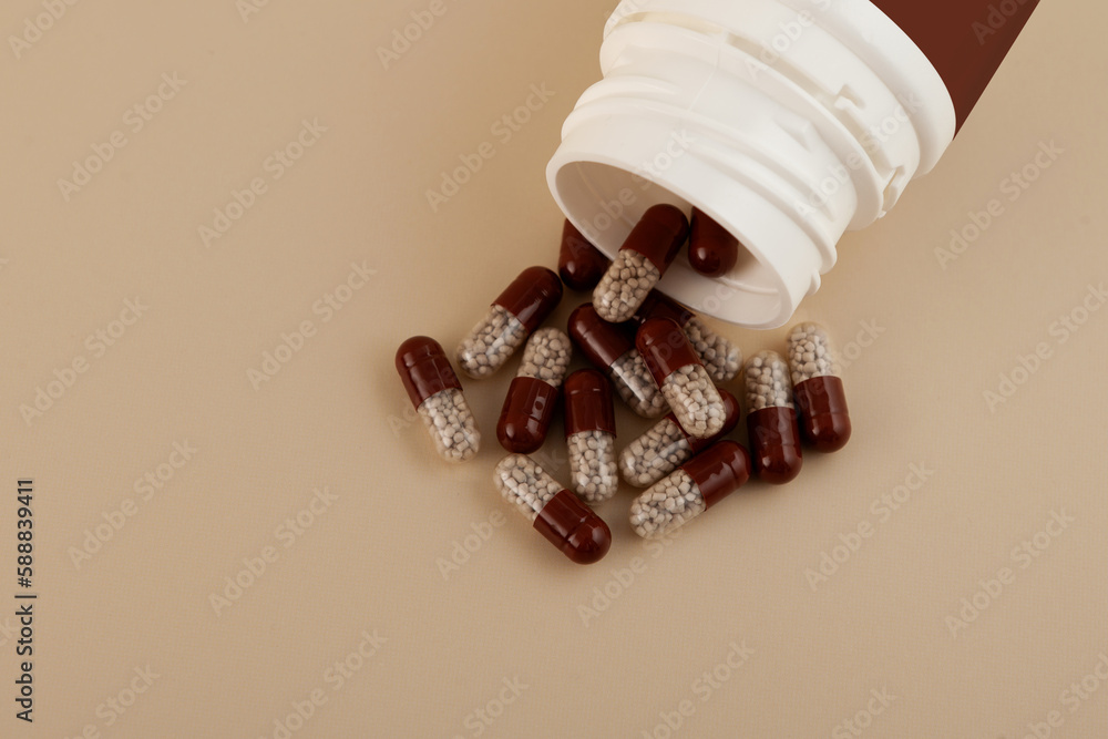 Pancreatin capsules or Creon scattered on beige surface. Pancreatic ...