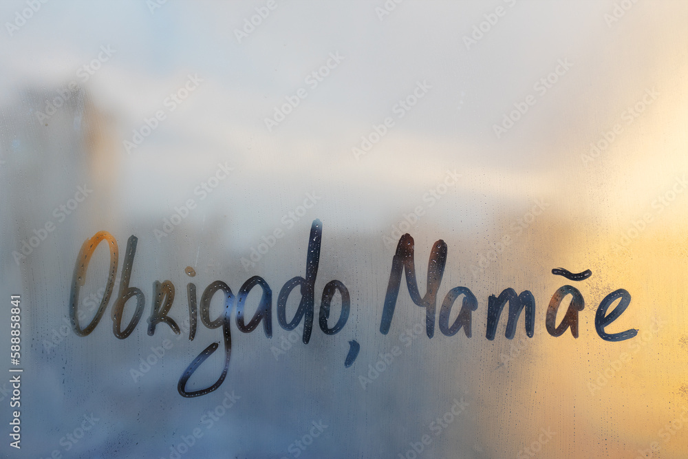 Handwritten lettering text Obrigado Mamae in Portuguese language is Thank you mommy in english ...