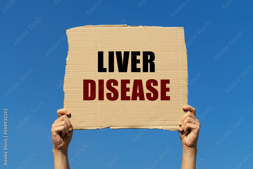 Liver disease text on box paper held by 2 hands with isolated blue sky ...