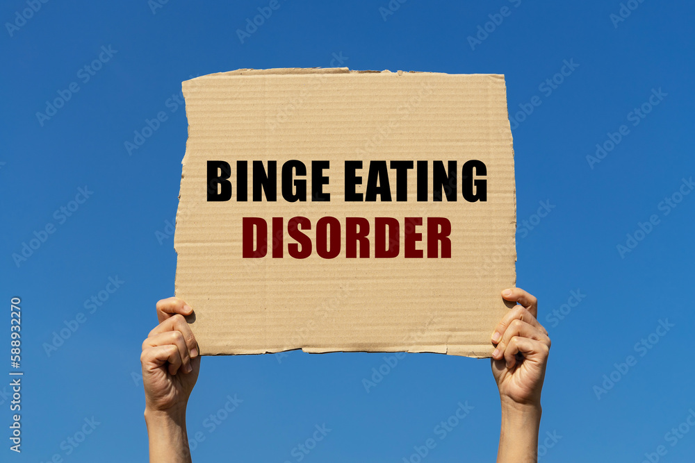 Binge eating disorder text on box paper held by 2 hands with isolated ...