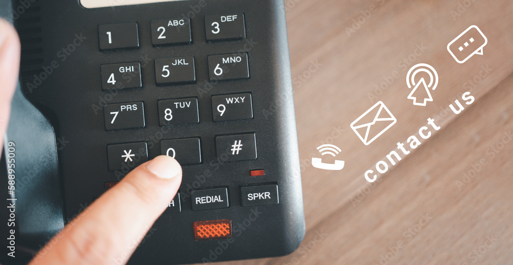The black telephone on desk with icons for customer support, contact us ...
