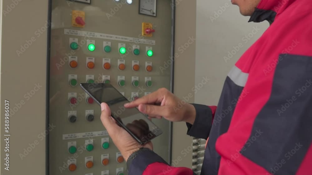 A Electrical Engineer working front HVAC control panels, Technician ...