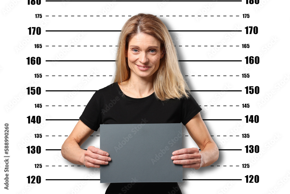 Criminal mugshot. Arrested woman with blank card against height chart ...