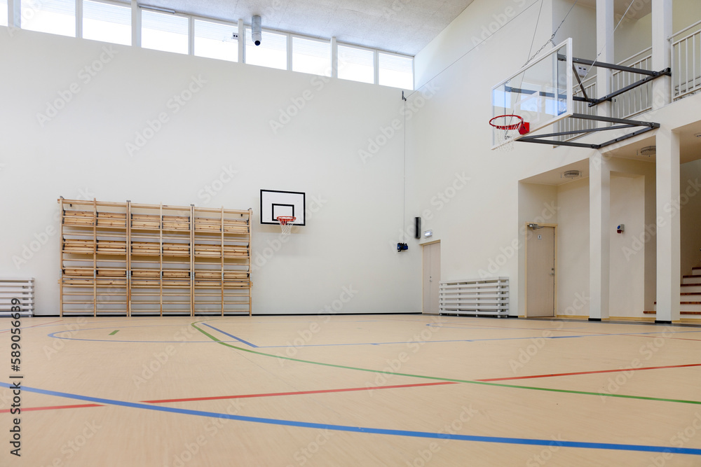 Indoor basketball court at a school. Wooden floor and marked court, a ...