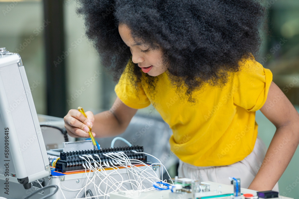 Girl female teen children concentrate enjoy Machine Learning Robot is ...