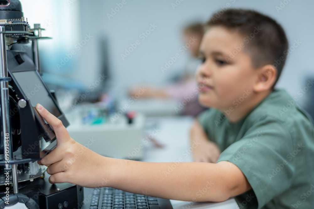 Boy male teen child concentrate enjoy Machine Learning Robot is Moving ...