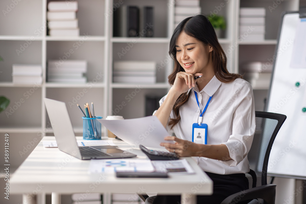 Charming Young asian businesswoman sitting on laptop computer in the ...