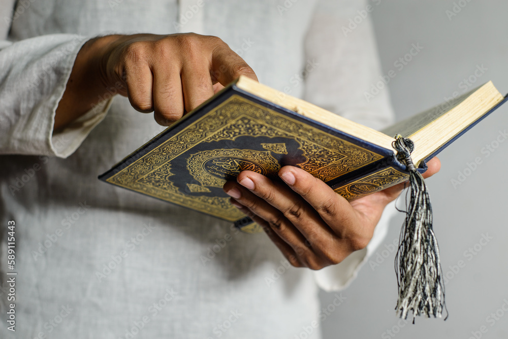 Foto de Holy Quran in Hand with arabic calligraphy meaning of Al Quran ...