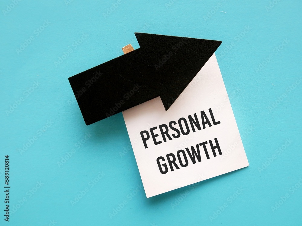 Black arrow on blue background with paper note PERSONAL GROWTH, process ...