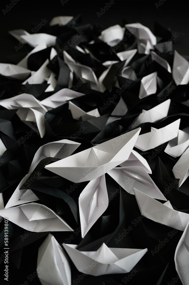 Levitating white and black paper ships Stock Photo | Adobe Stock