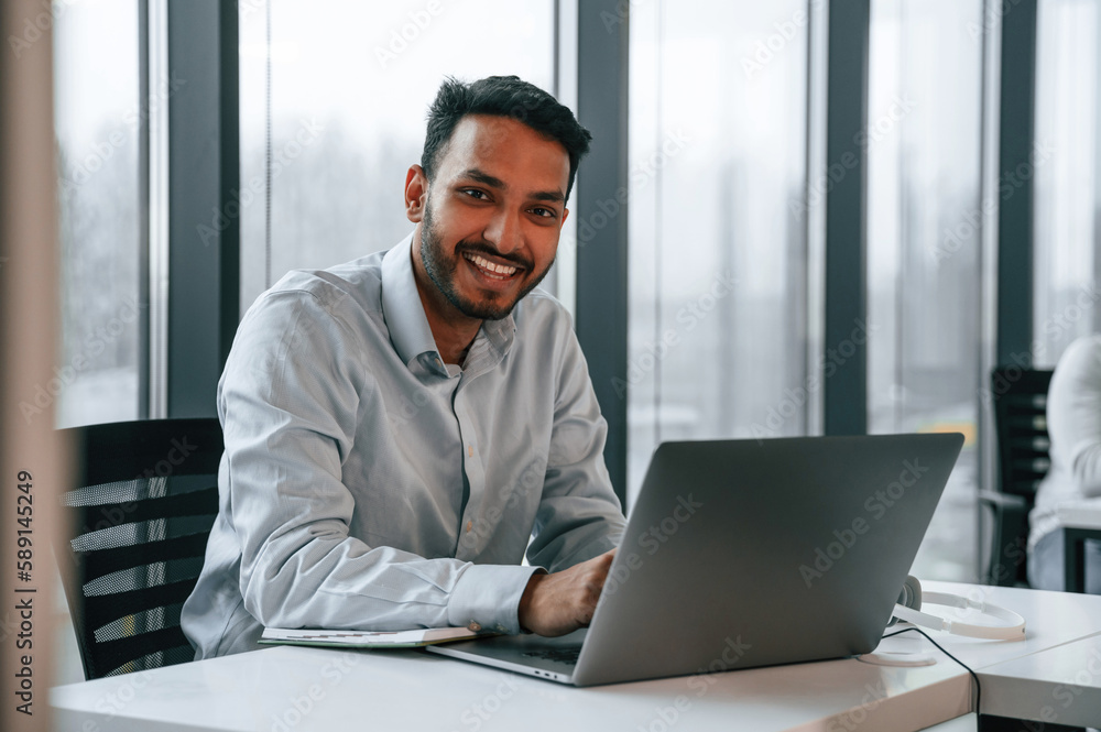 Beautiful indian man is working in the office by laptop Stock Photo ...