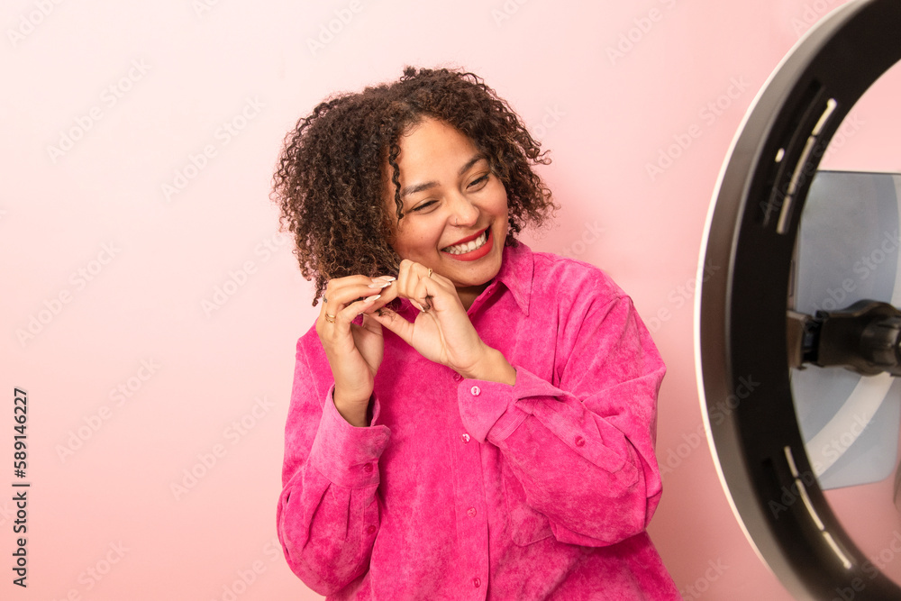 Calm ethnic woman demonstrating hairstyle during beauty tutorial Stock ...