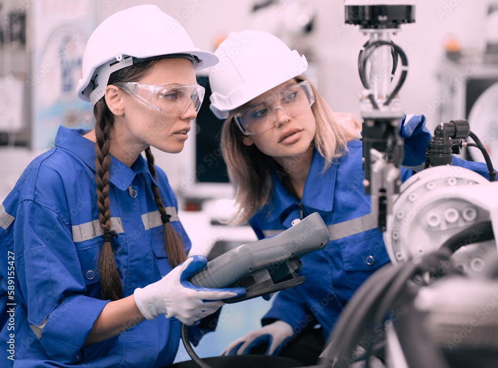 Robotic engineer monitoring robot arm connection for maintenance in ...
