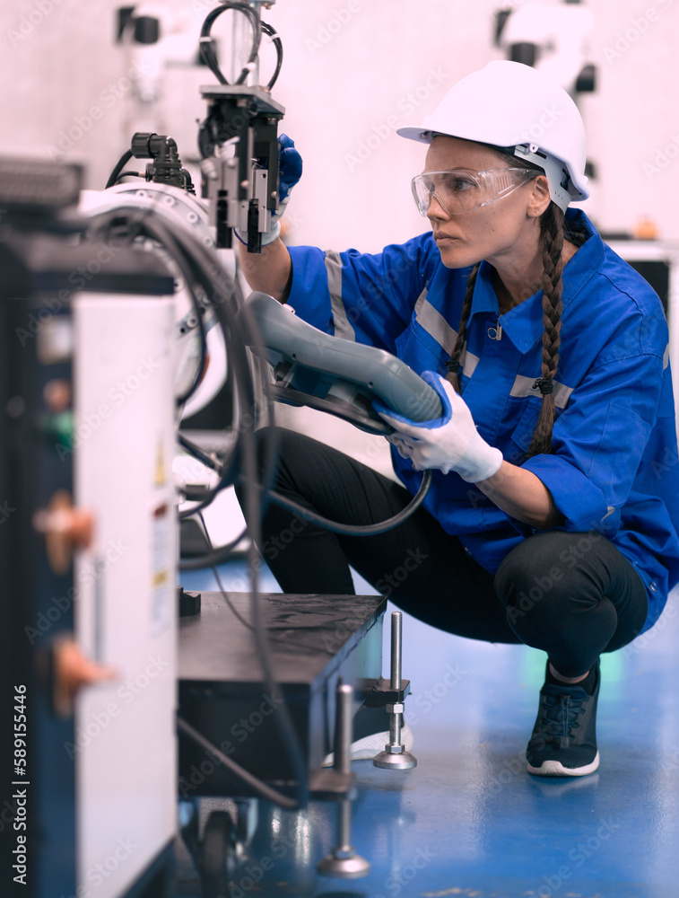 Robotic engineer monitoring robot arm connection for maintenance in ...