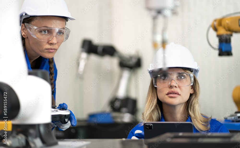 Robotic engineer monitoring robot arm connection for maintenance in ...