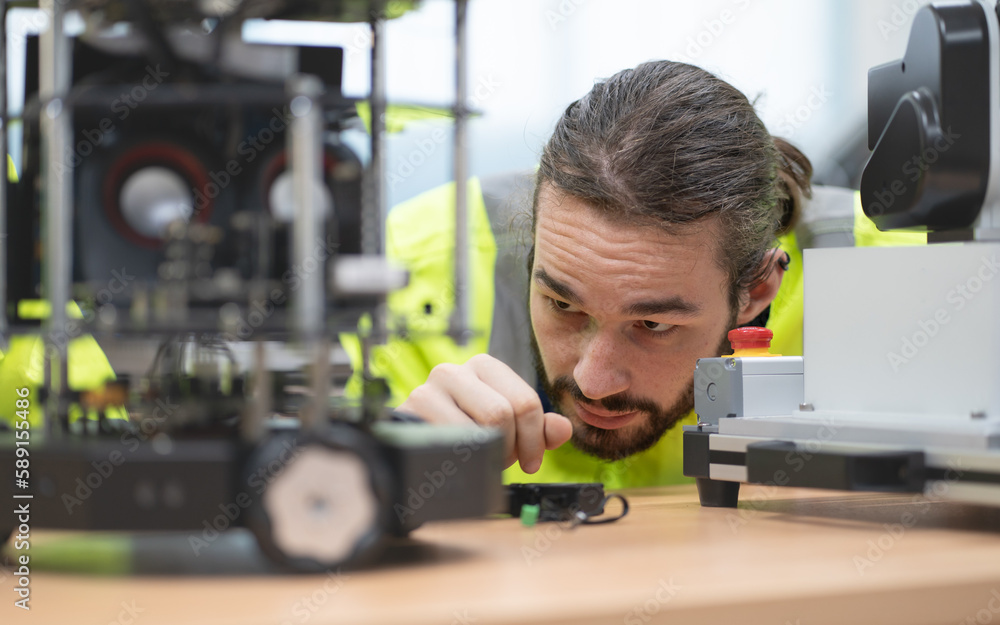 Robotic engineer monitoring robot arm connection for maintenance in ...