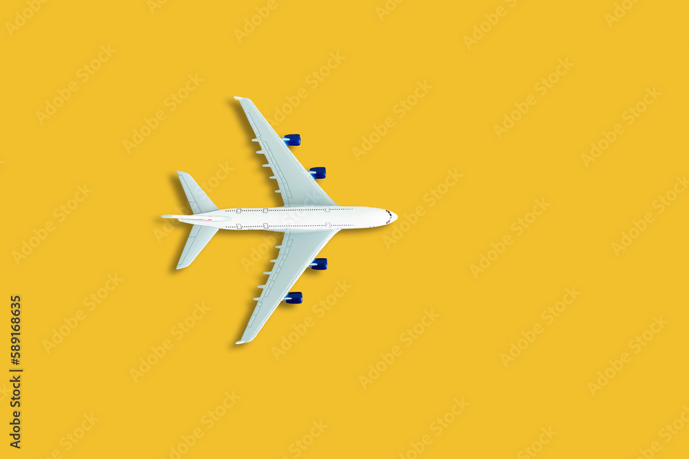 Flat lay design of travel concept with plane on yellow background with ...