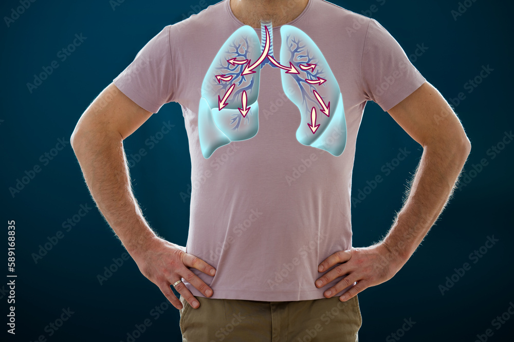 The man standing on a dark background. Picture of a human lungs ...