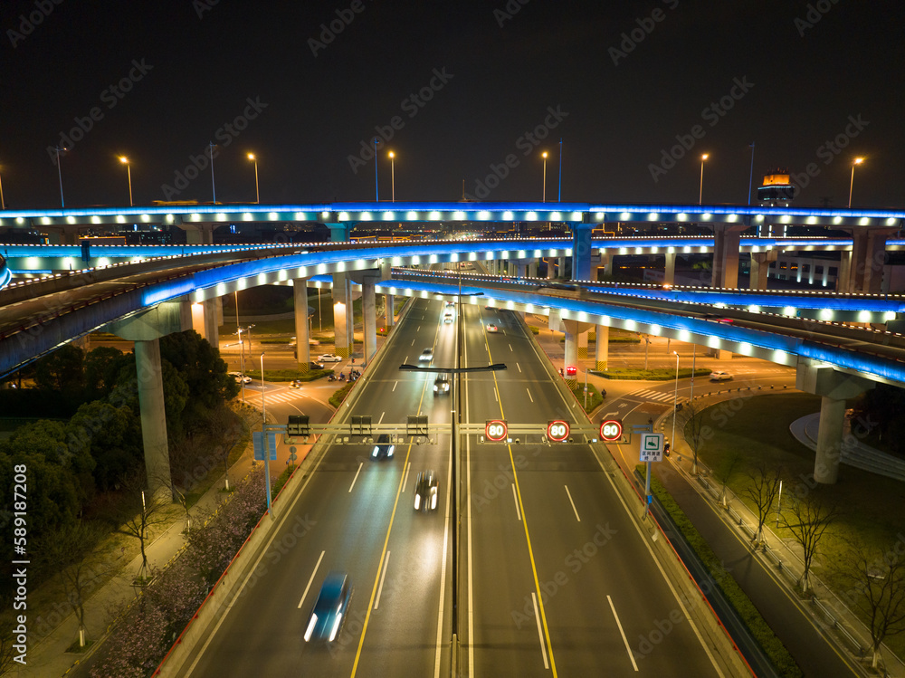 Aerial drone slow shutter night shot of urban elevated toll ring road ...