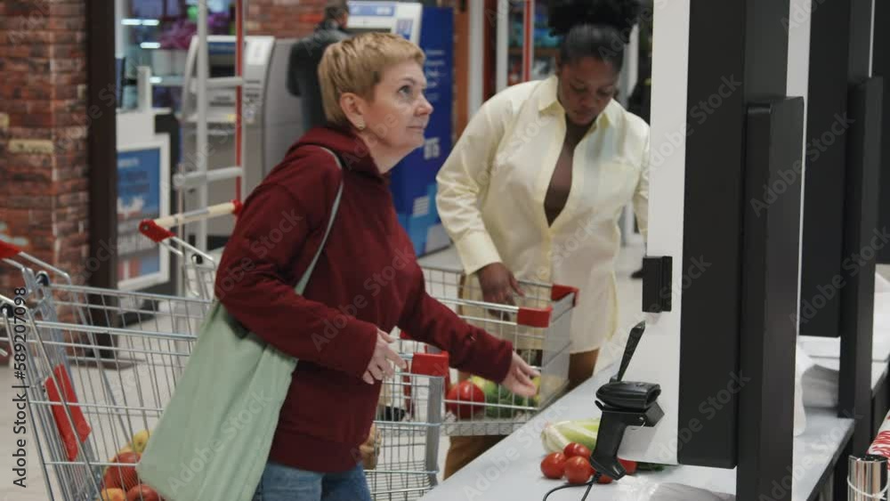 Customers putting products on cash counter for payment after shopping ...