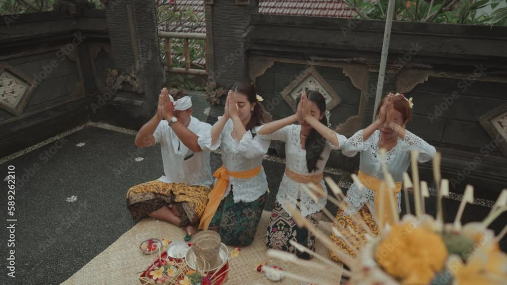 Balinese Family Performing Hindu Ritual Prayer Daily Offerings at Home ...