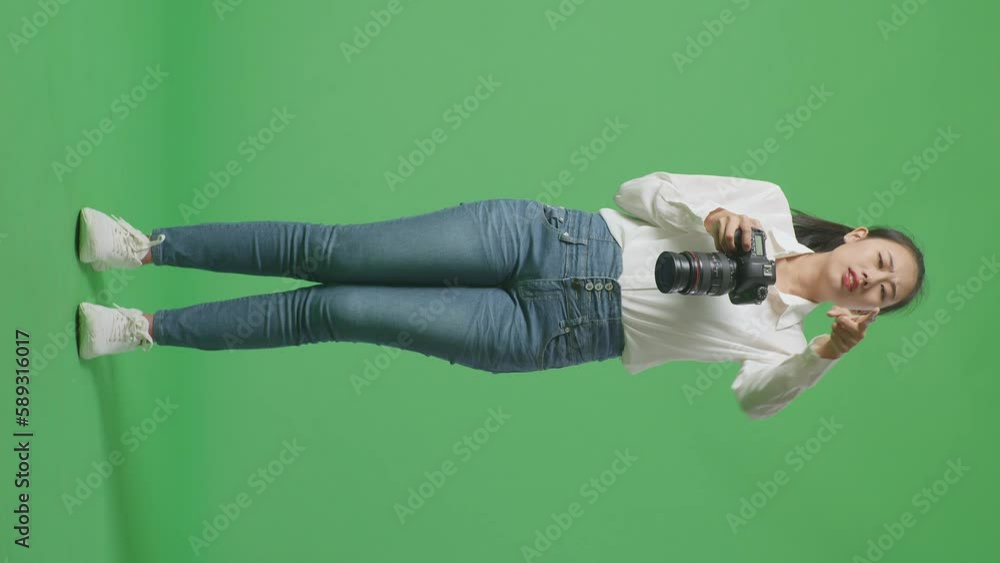 Full Body Of Serious Asian Photographer Looking Picture In Camera And ...
