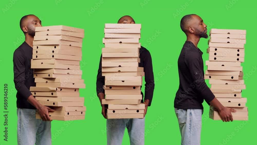 African american man holding pile of pizza boxes stack over greenscreen ...