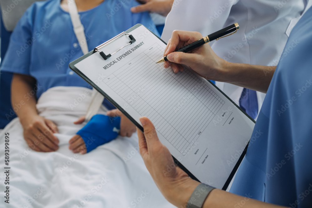 Injured patient showing doctor broken wrist and arm with bandage in ...