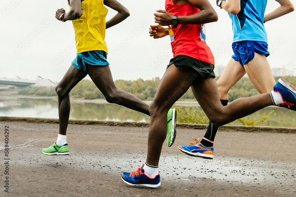 group african and european runners running marathon race, legs jogger ...