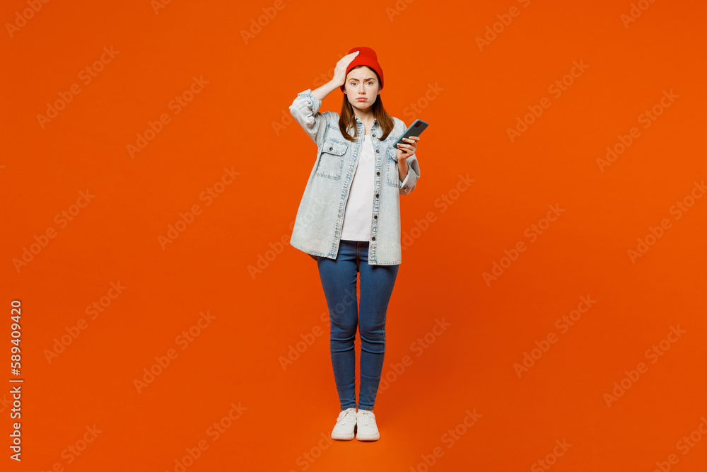 Full body young scared fearful shocked sad troubled woman wear denim ...